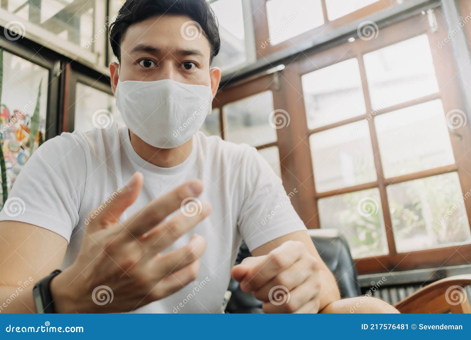 Man Influencer with Mask is Talking with His Camera in a Cafe. Stock ...