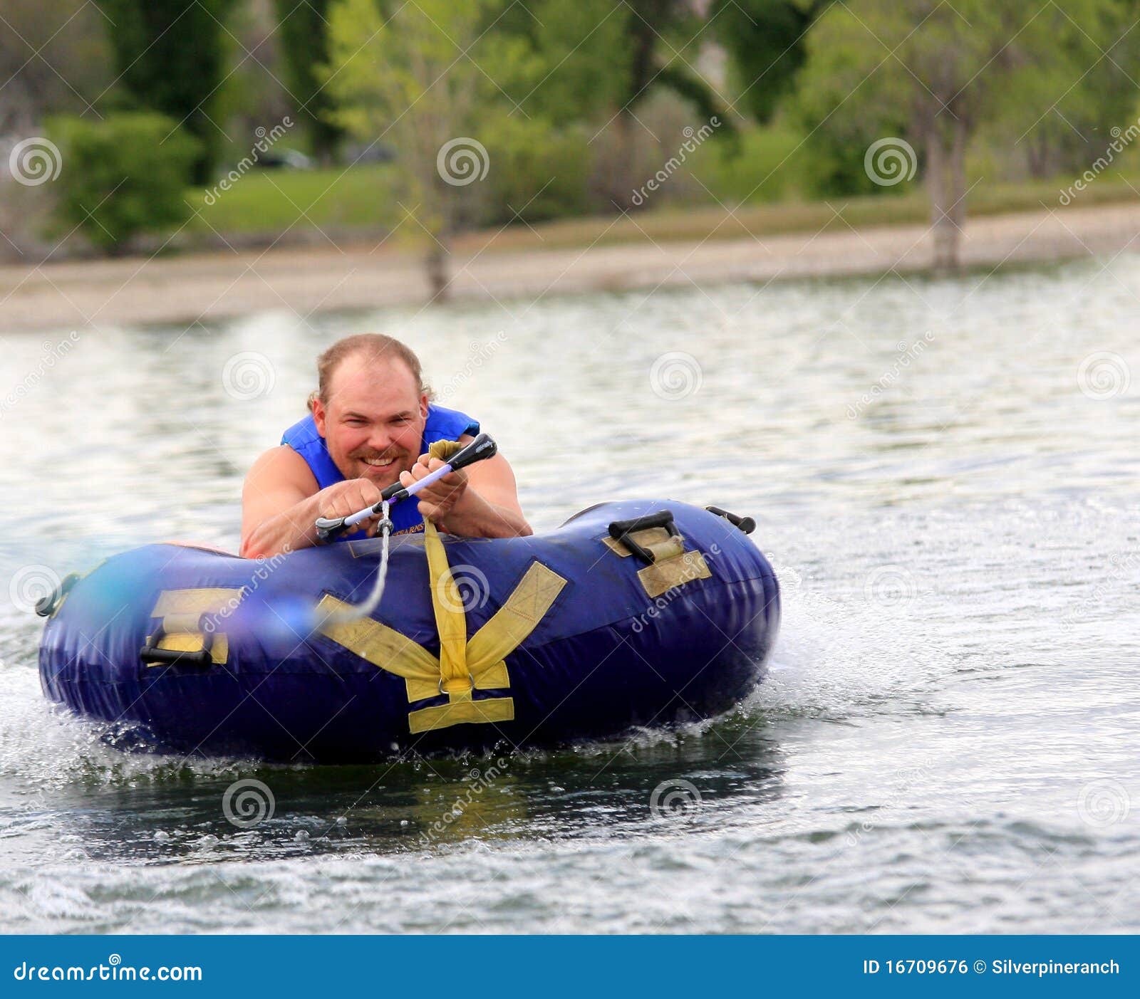 Man innertubing on lake stock photo. Image of water, seasonal - 16709676