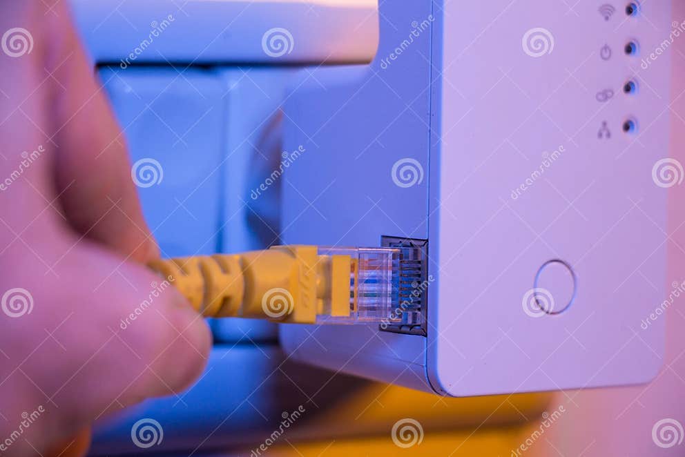 Man Insert Ethernet Cable into WiFi Extender Device Which is in Stock ...