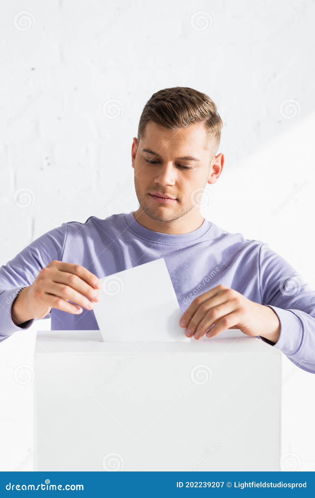 Man Inserting Ballot into Polling Booth Stock Image - Image of choose ...