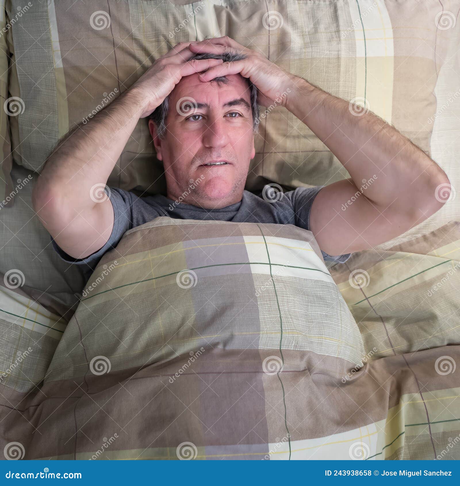 Man with Insomnia Lying in Bed and Staring at the Ceiling. Stock Photo ...