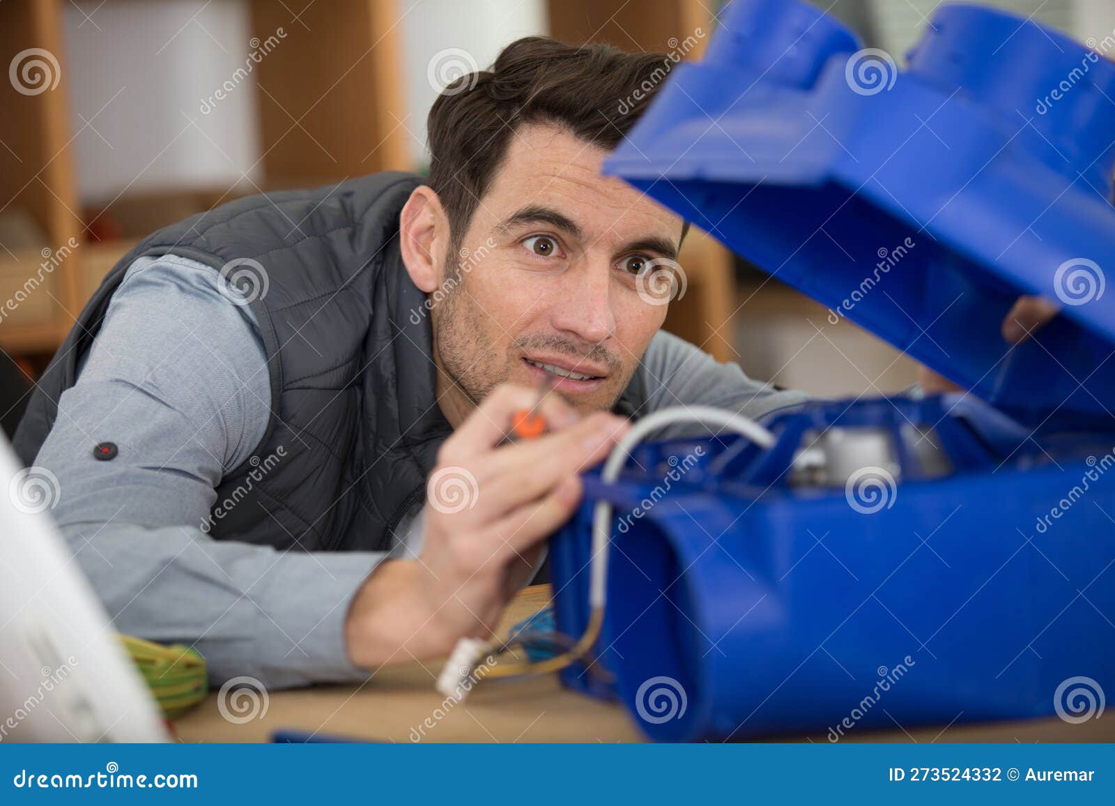 Man Inspecting Blue Plastic Box Housing Electrical Component Stock ...