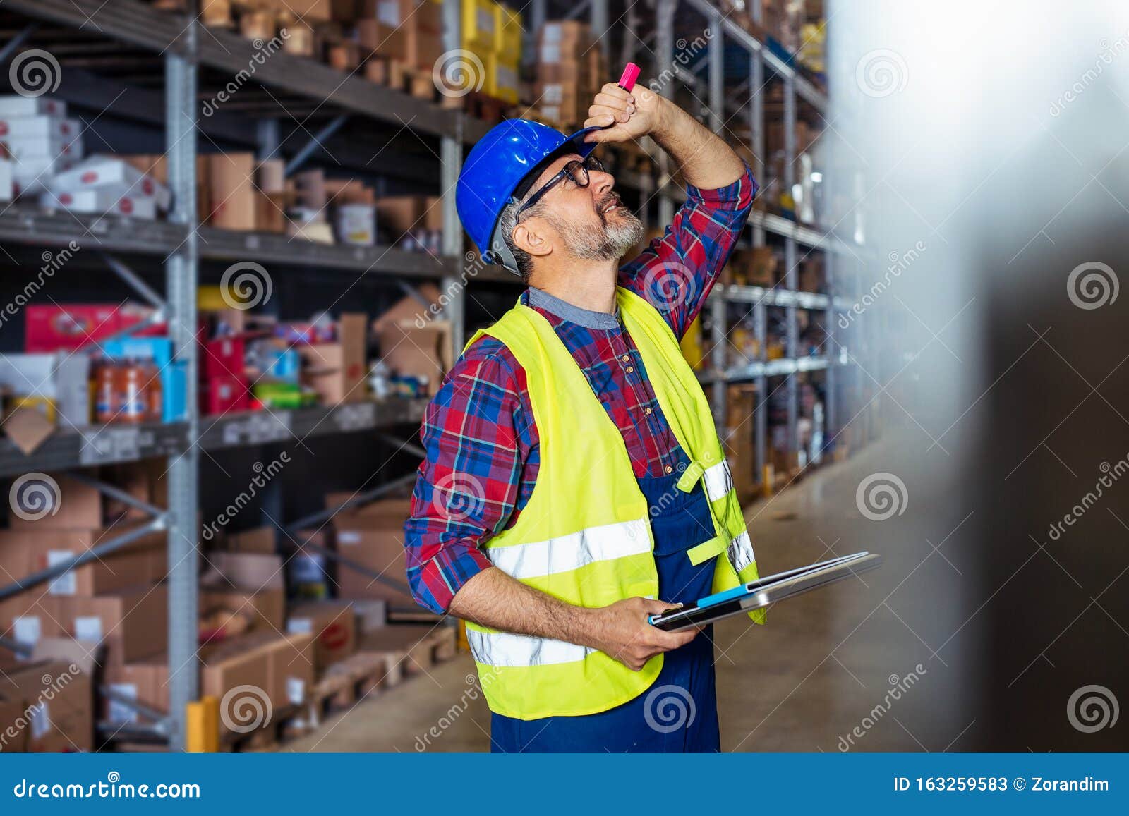 Man Inspecting Boxes in Distribution Warehouse. Stock Image - Image of ...