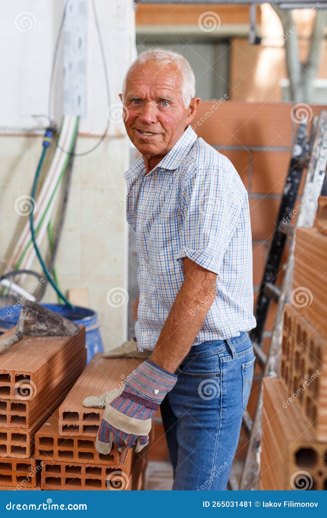 Man Inspecting Brick for Installing Wall Stock Image - Image of ...