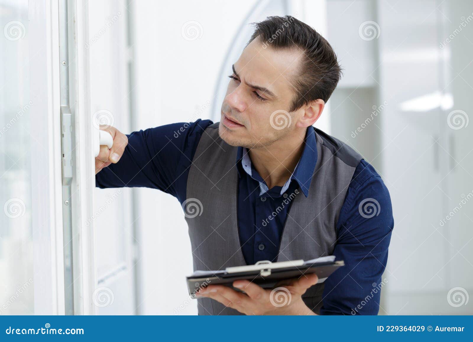 Man Inspecting Door Handle in Property Stock Image - Image of caucasian ...