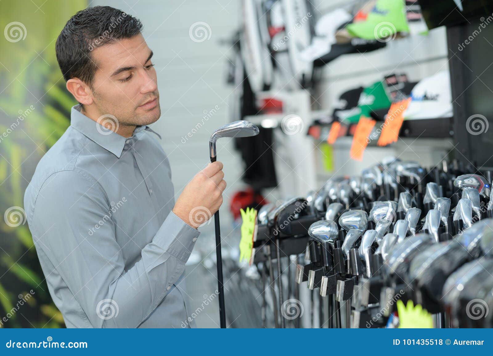 Man inspecting golf clubs stock photo. Image of customer - 101435518
