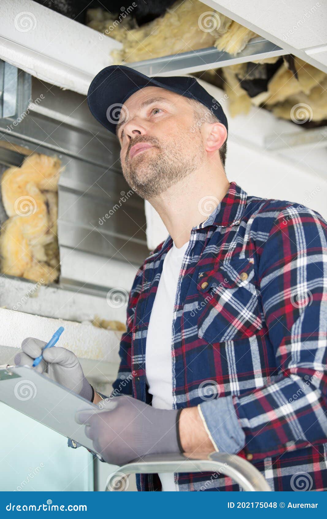 Man Inspecting Insulation in Building Stock Photo - Image of ...