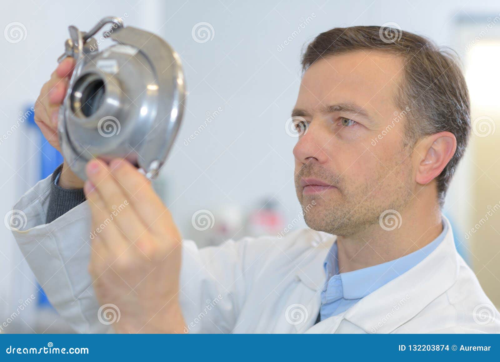Man Inspecting Metal Component Stock Photo - Image of white, technician ...