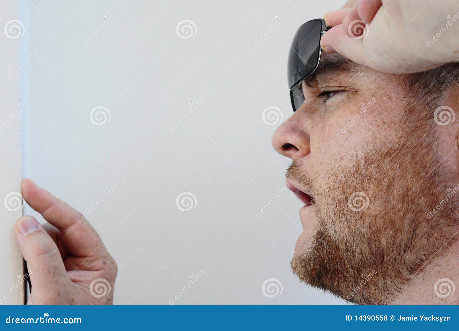 Man Inspecting Wall stock photo. Image of sunglasses - 14390558