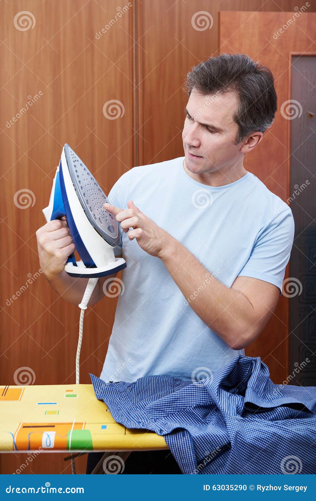 Man Inspects a Hot Iron before Ironing Stock Photo - Image of chore ...
