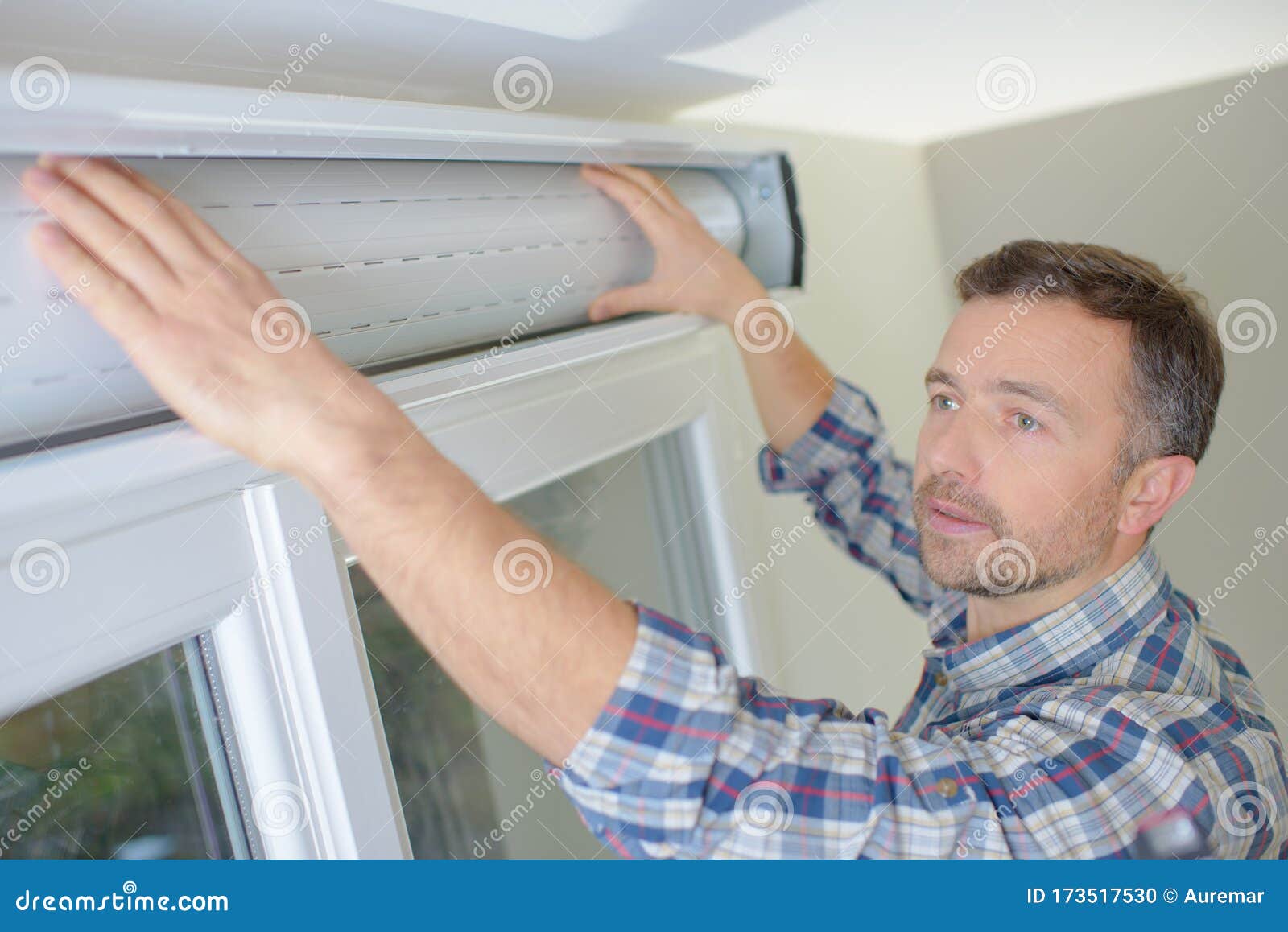 Man installing blinds stock photo. Image of design, line - 173517530