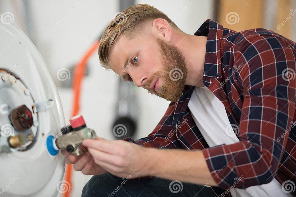 Man installing boiler stock photo. Image of equipment - 264199602