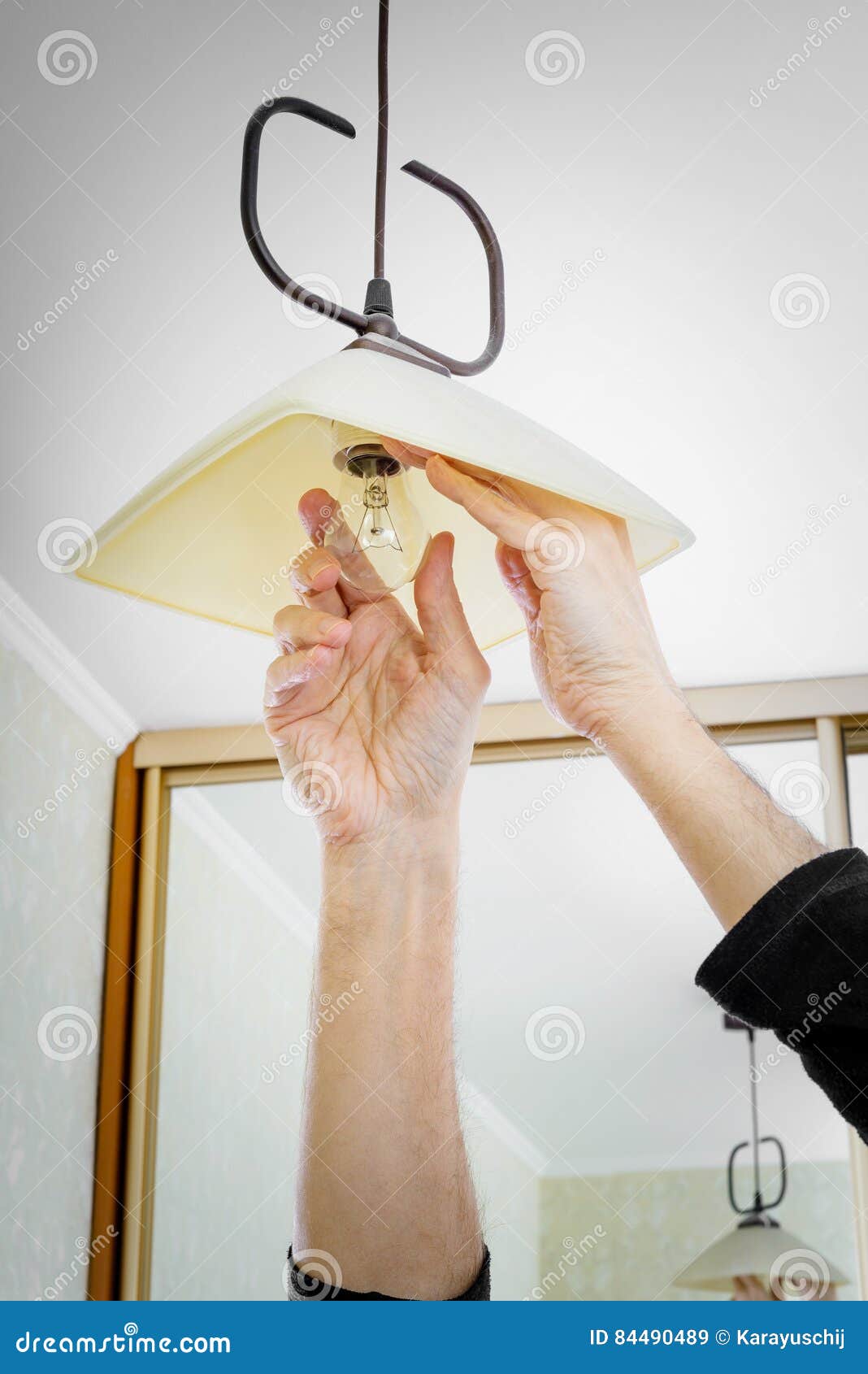 Man Installing or Changing a Bulb, Fixing it To the Socket Stock Image ...
