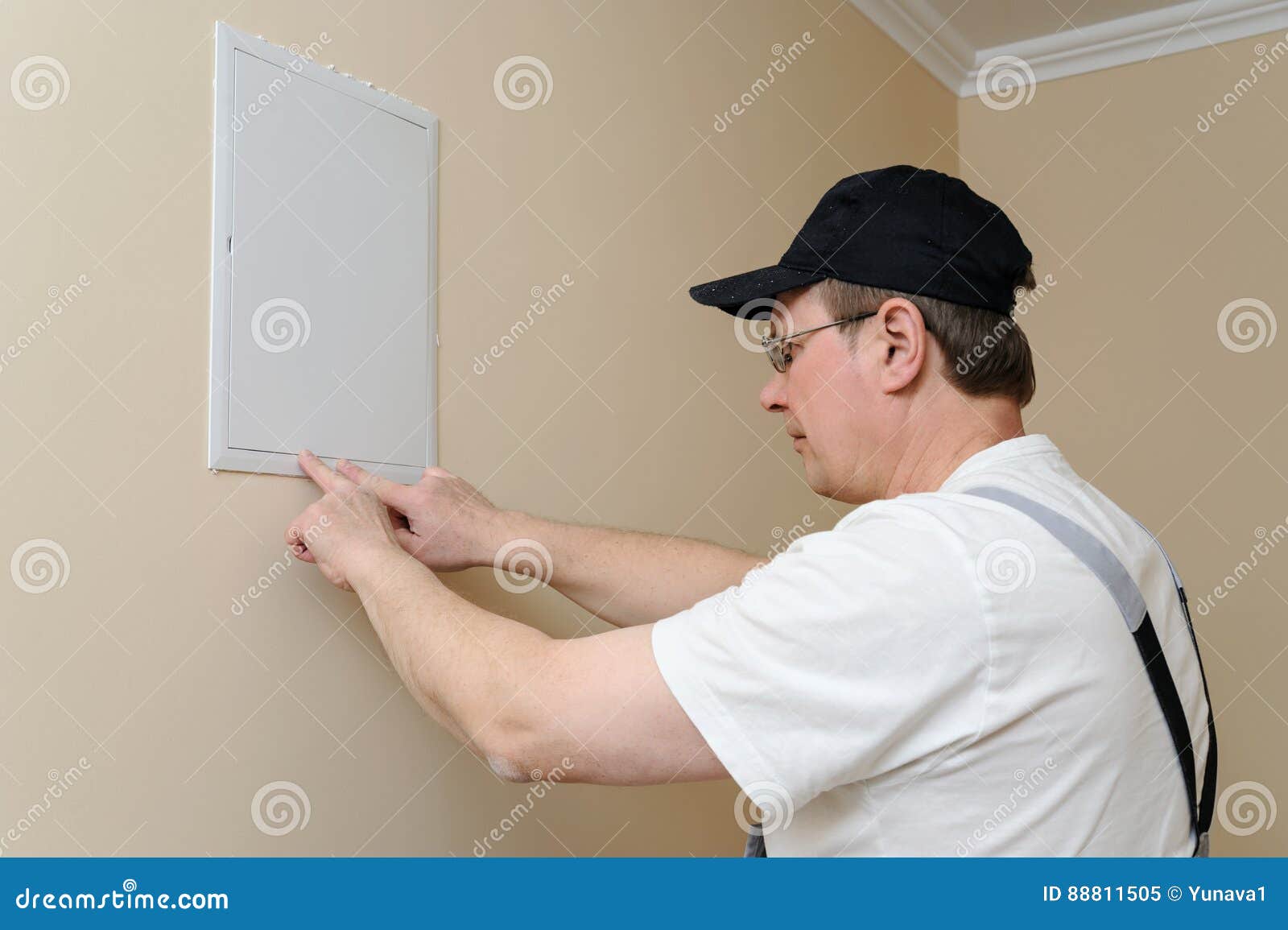 Man is Installing Hatch on the Wall. Stock Image - Image of close, home ...
