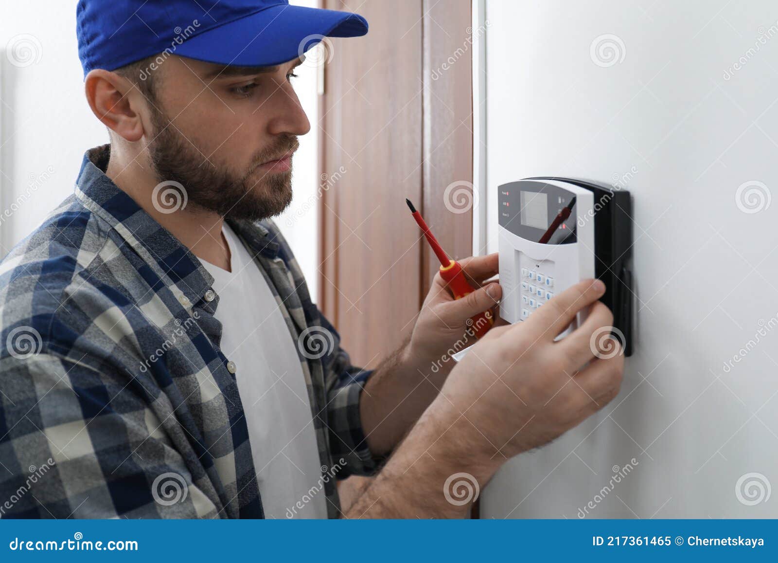 Man Installing Home Security System on White Wall in Room Stock Image ...