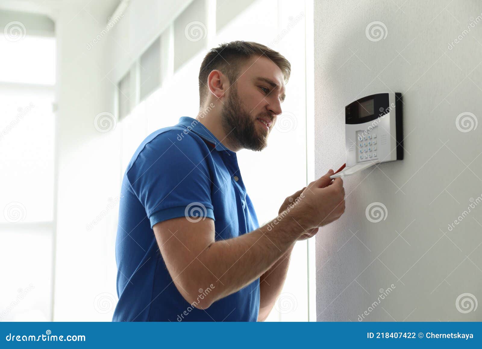 Man Installing Home Security System on White Wall in Room Stock Photo ...