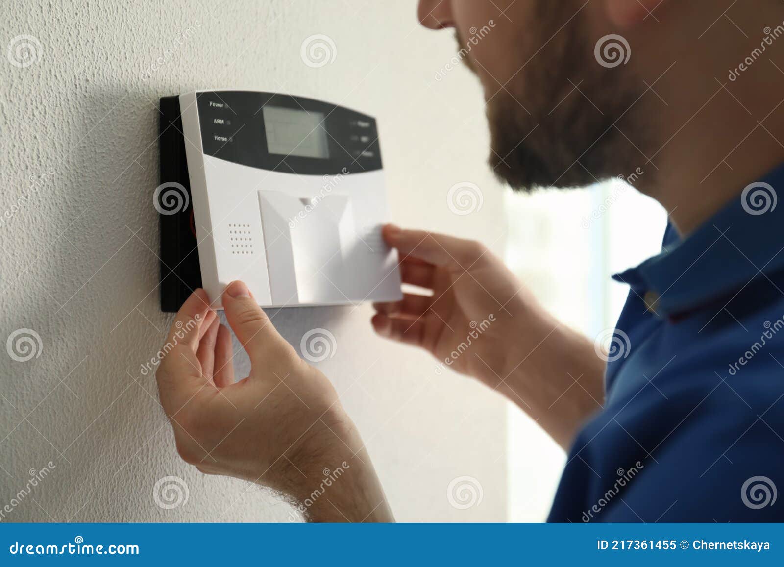 Man Installing Home Security System on White Wall in Room, Closeup ...