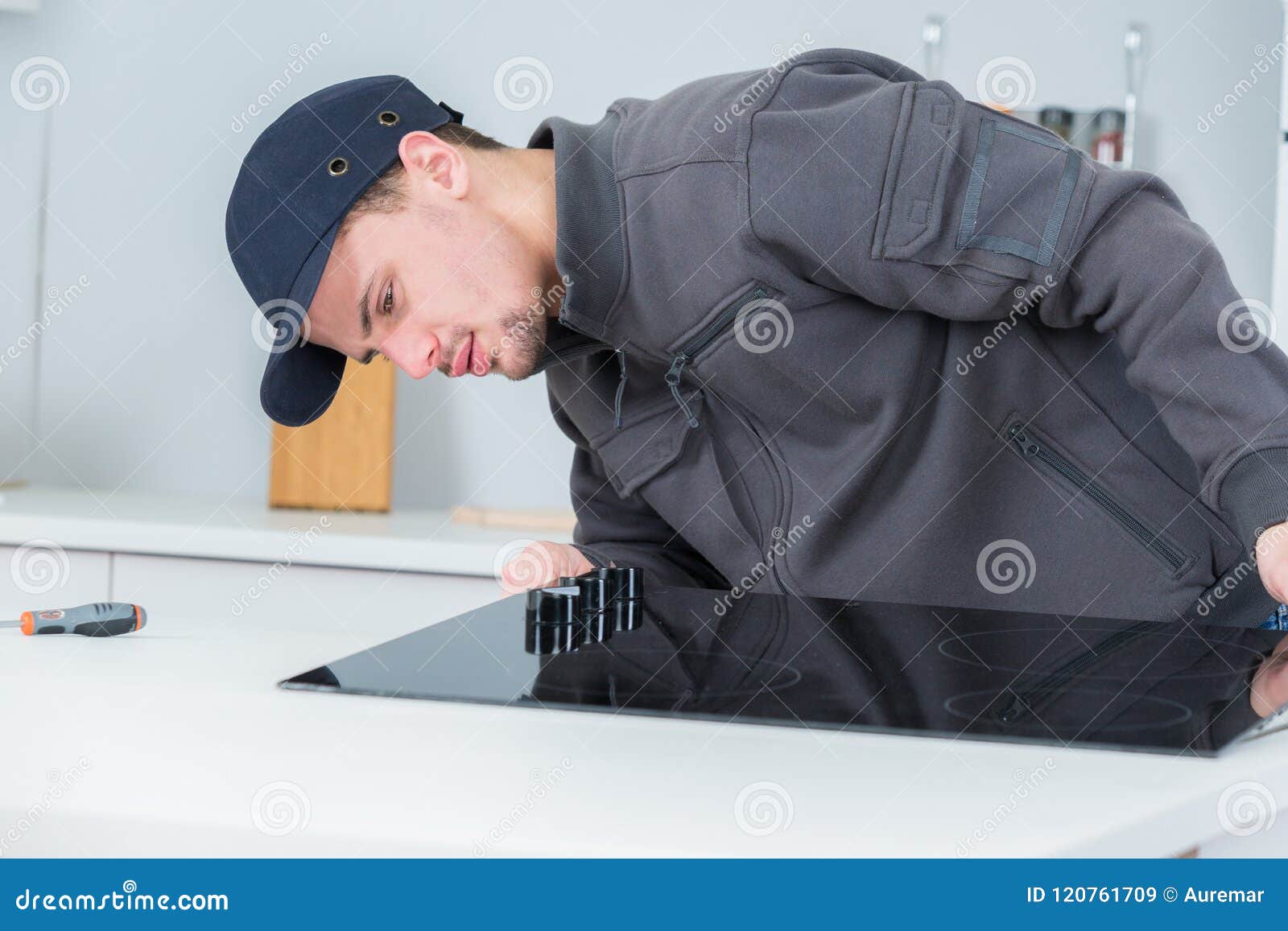 Man installing kitchen hob stock image. Image of adult - 120761709