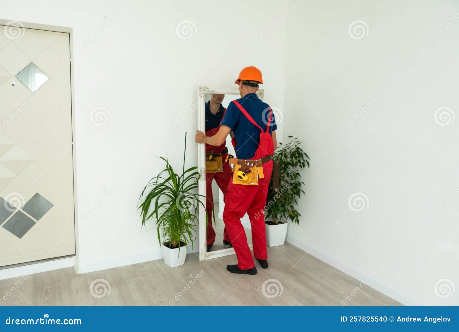 Man Installing a Mirror on Wall Stock Photo - Image of frame, carpenter ...