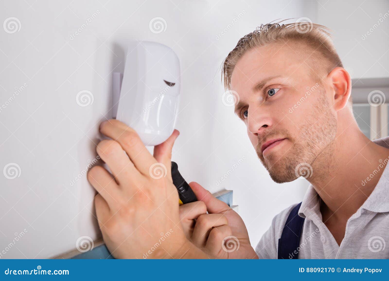 Man Installing Motion Detector for Security System Stock Photo - Image ...
