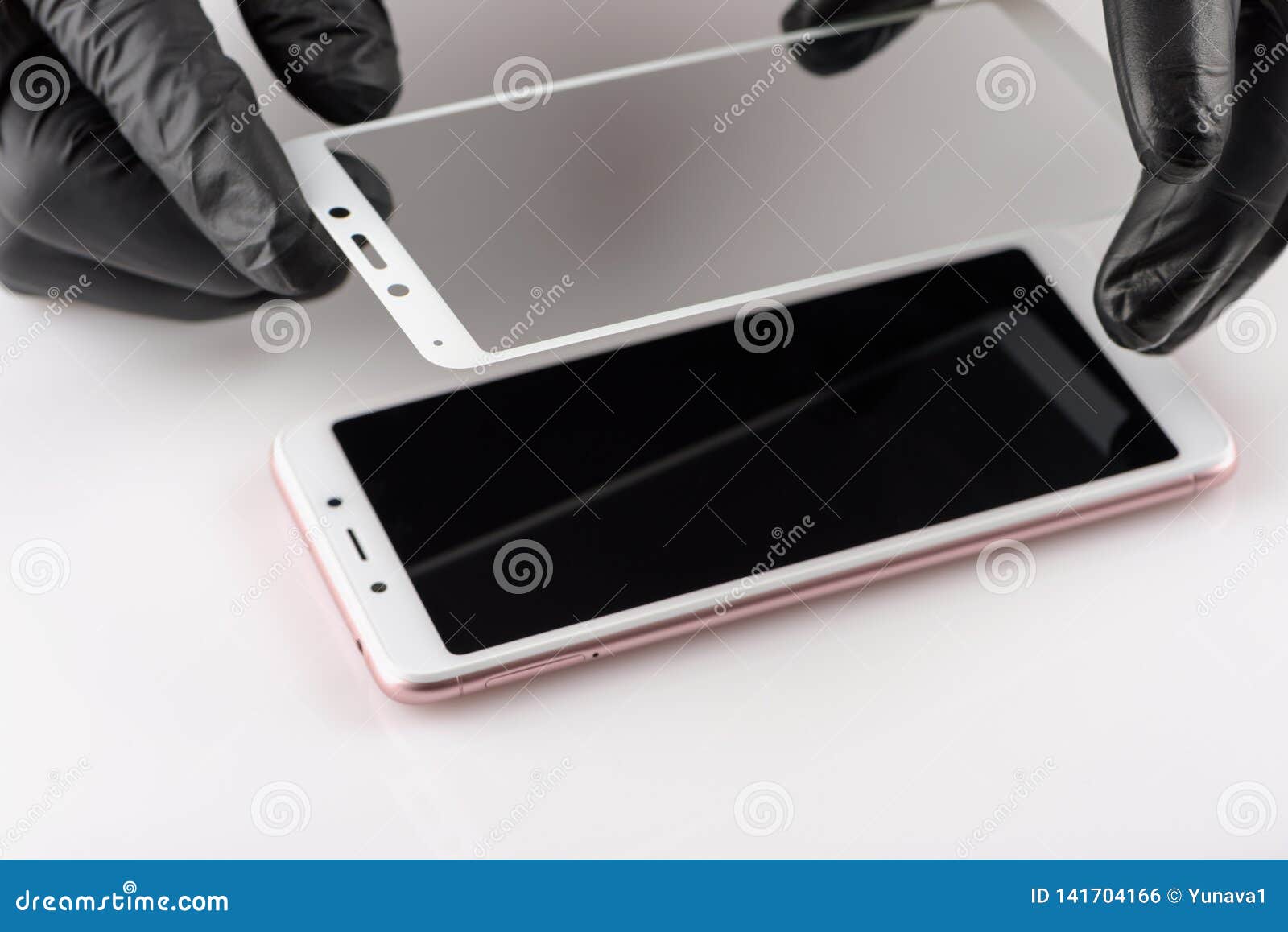 A Man is Installing a Protective Glass on a Smartphone Stock Photo ...