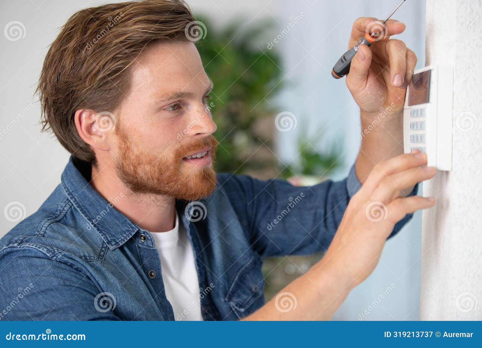 Man Installing Security System Door Sensor on Wall Stock Image - Image ...