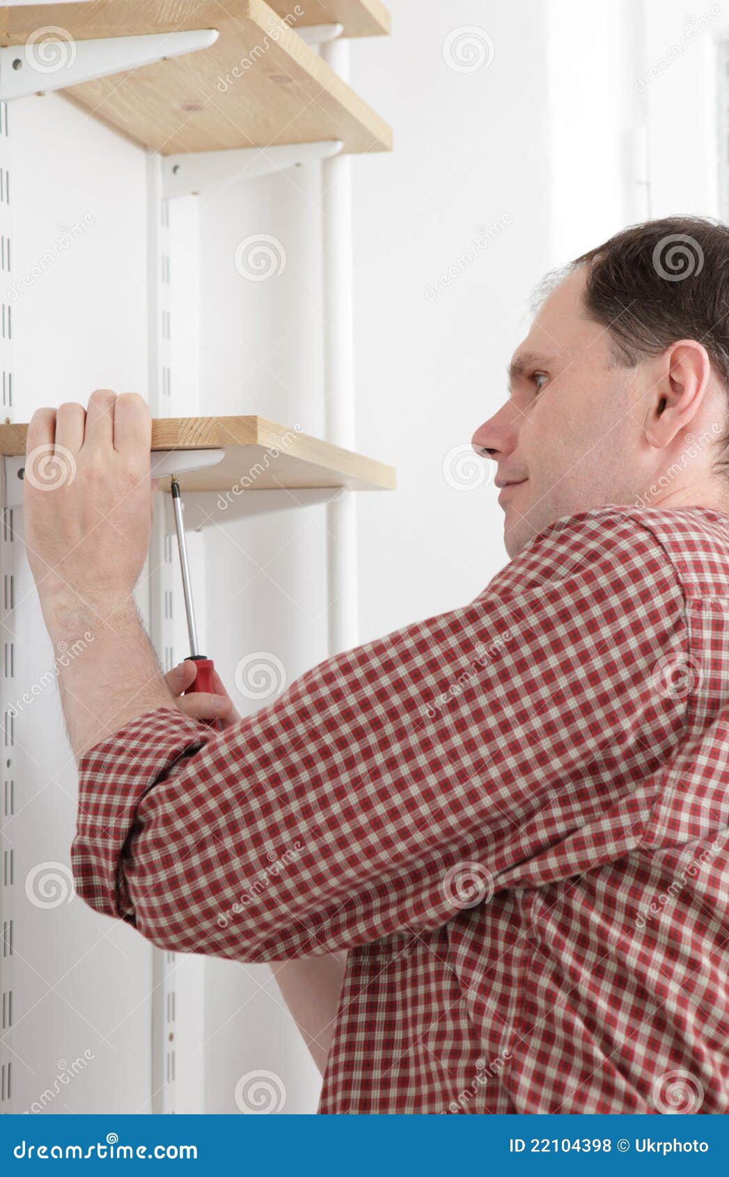 Man installing shelves stock photo. Image of renovation - 22104398