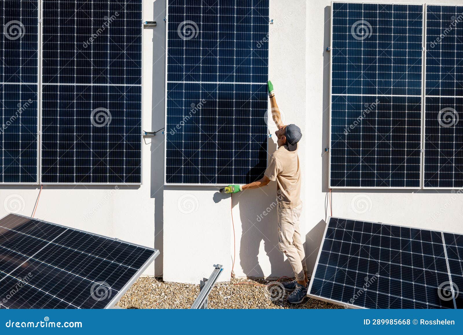 Man Installing Solar Panels on a Rooftop Stock Photo - Image of home ...