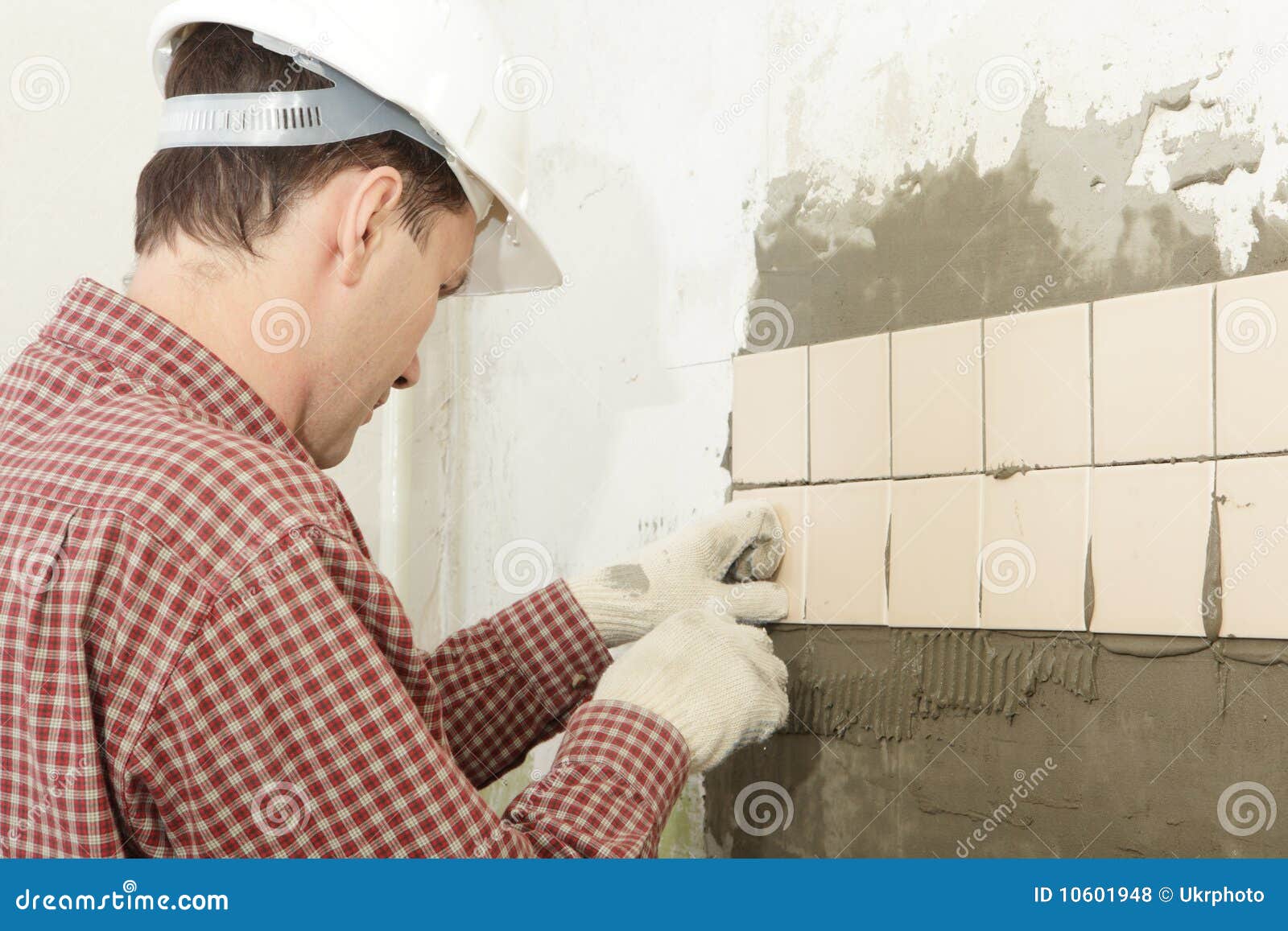 Man installs ceramic tile stock photo. Image of labor - 10601948