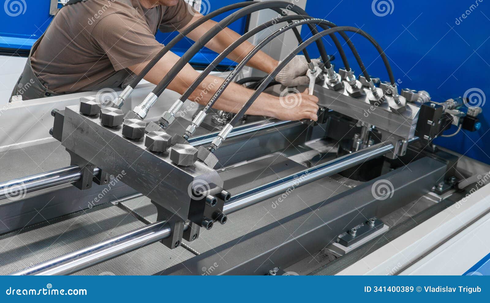 A Man Installs High Pressure Hoses into a Testing Machine. Product ...