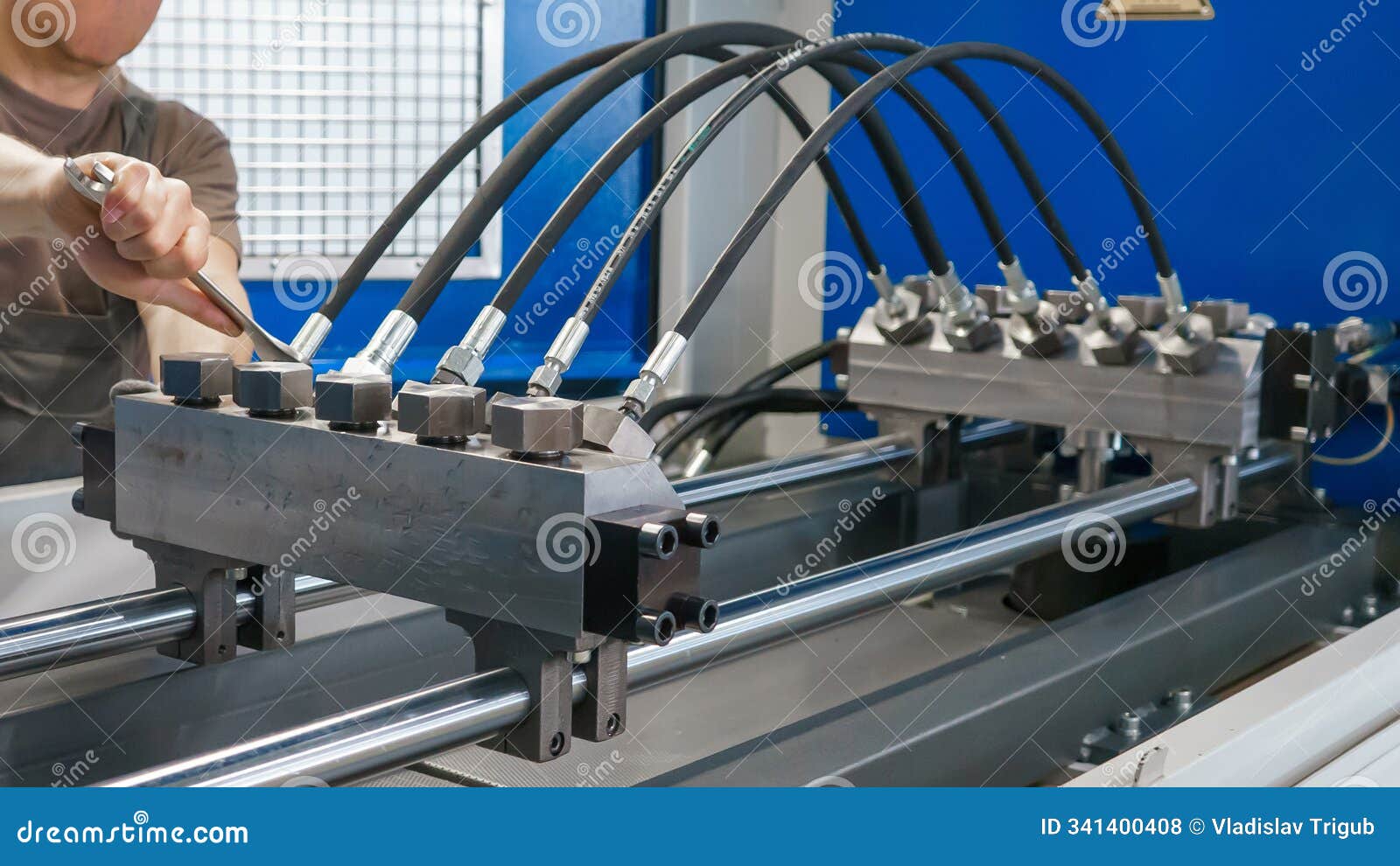 A Man Installs High Pressure Hoses into a Testing Machine. Product ...