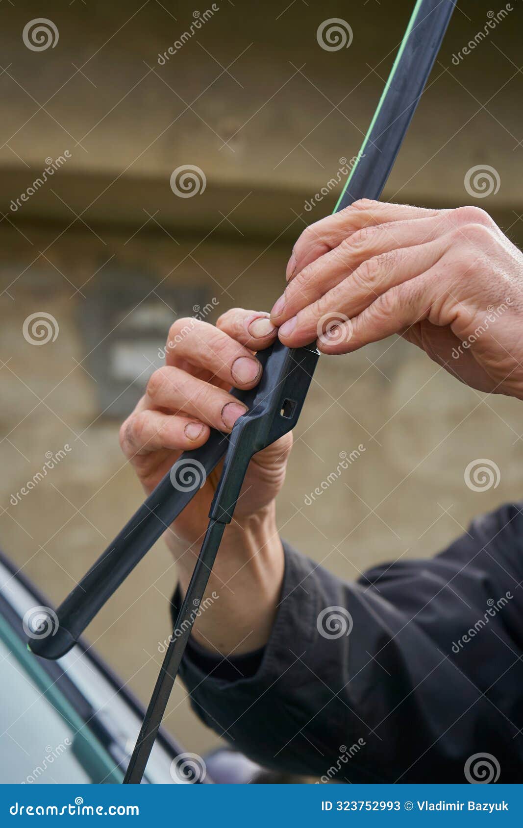 Man Installs the Windshield Wipers of the Car, a Man S Hands Install a ...