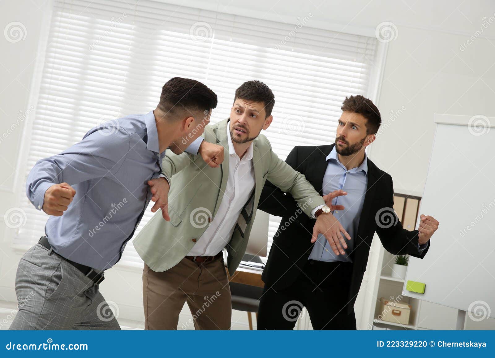 Man Interrupting Colleagues Fight at Work in Office Stock Photo - Image ...
