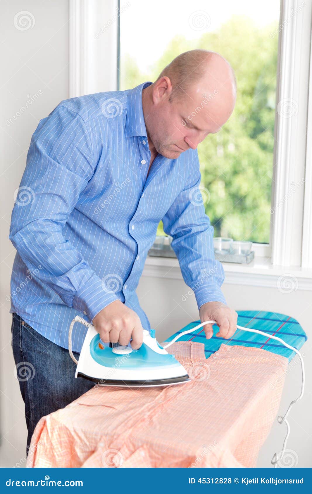 Man ironing his shirt stock photo. Image of face, board - 45312828