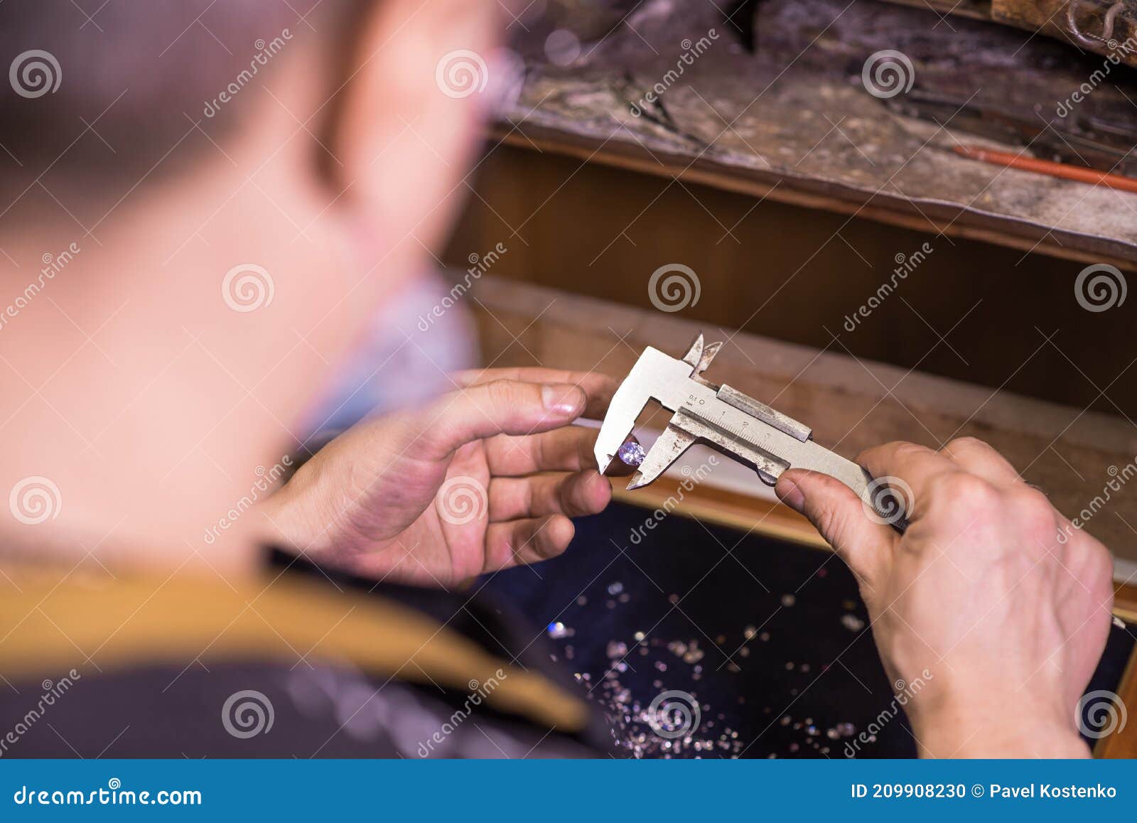 A Man Jeweler Makes an Accurate Measurement of a Gem Using a Caliper ...