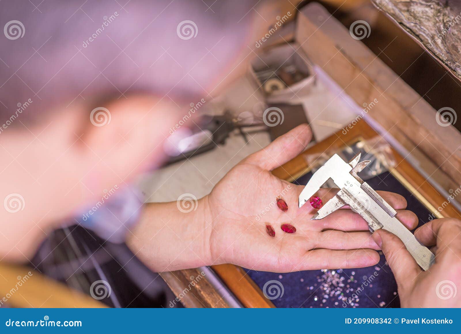 A Man Jeweler Makes an Accurate Measurement of a Gem Using a Caliper ...
