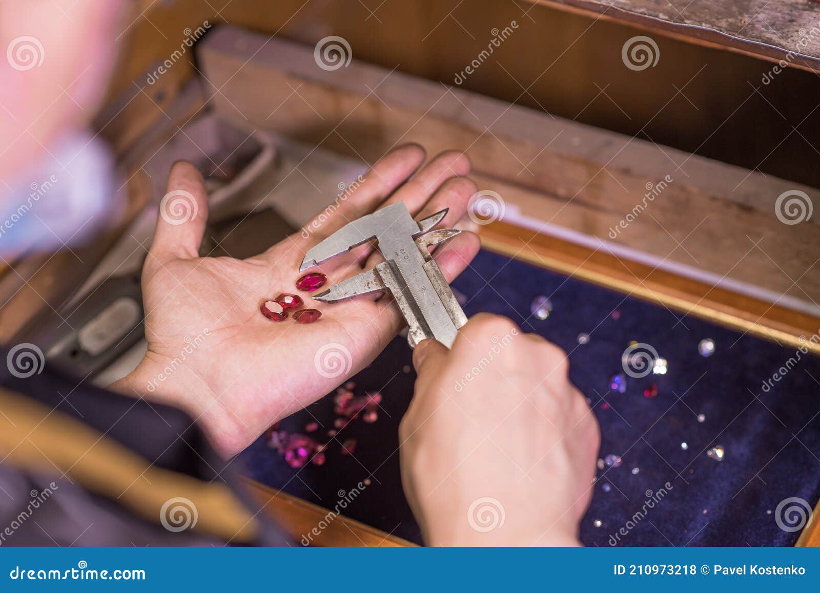 A Man Jeweler Makes an Accurate Measurement of a Gem Using a Caliper ...