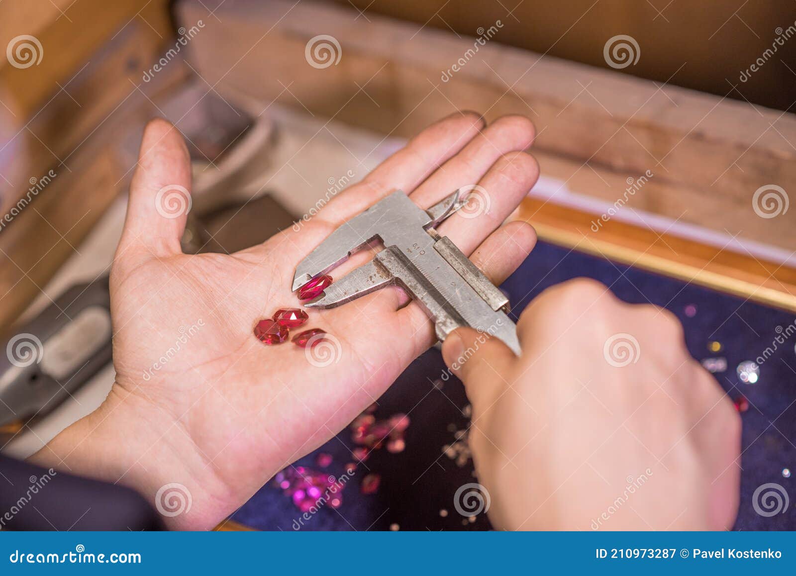 A Man Jeweler Makes an Accurate Measurement of a Gem Using a Caliper ...