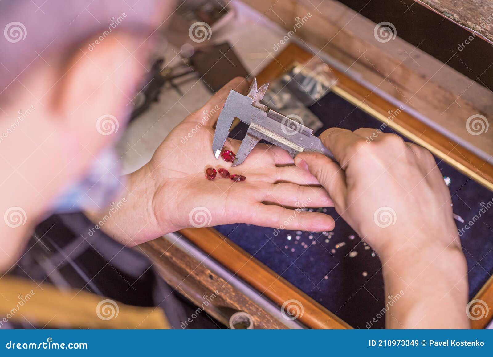 A Man Jeweler Makes an Accurate Measurement of a Gem Using a Caliper ...