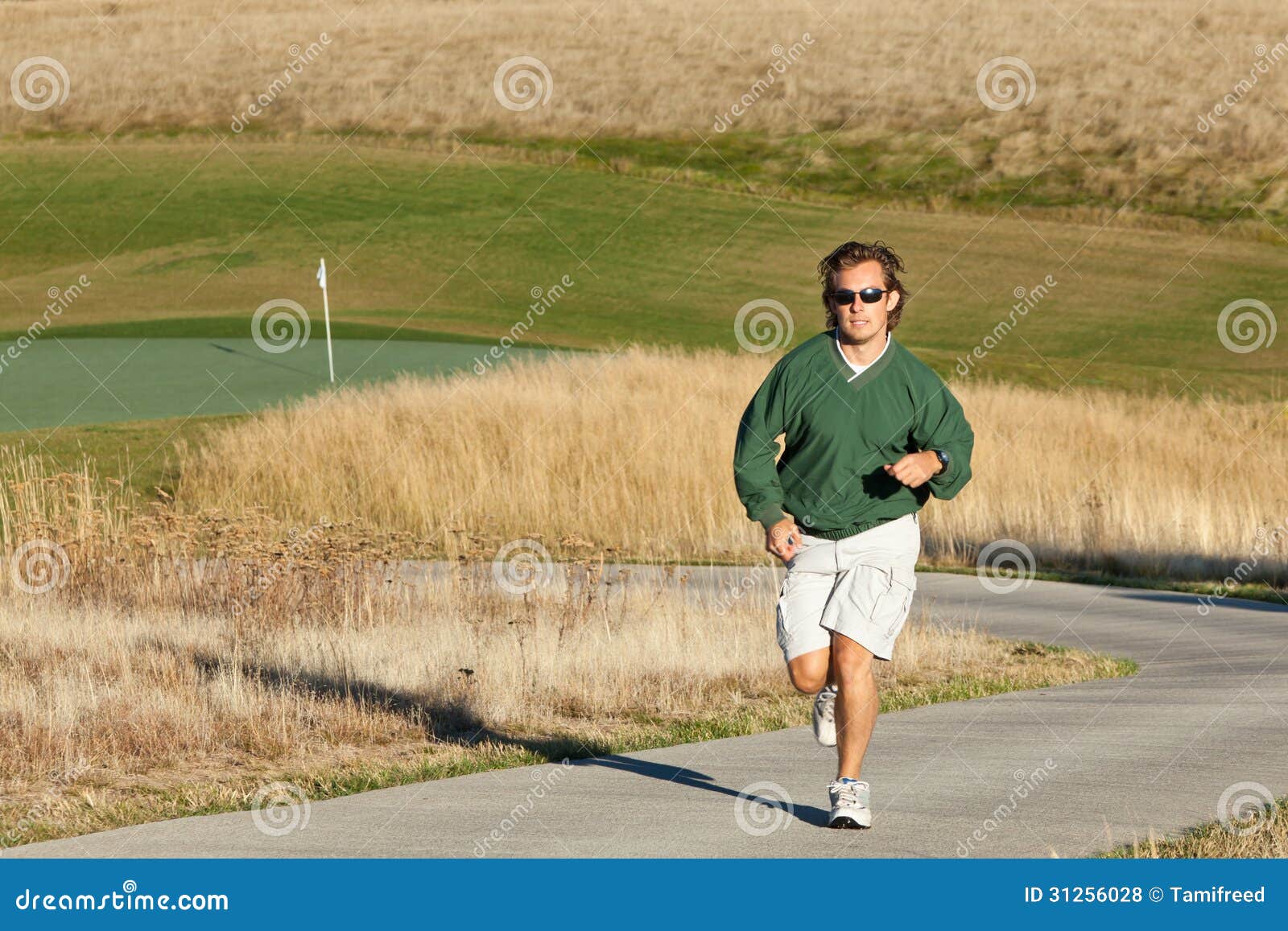 Man Jogging at Golf Course stock photo. Image of lawn - 31256028