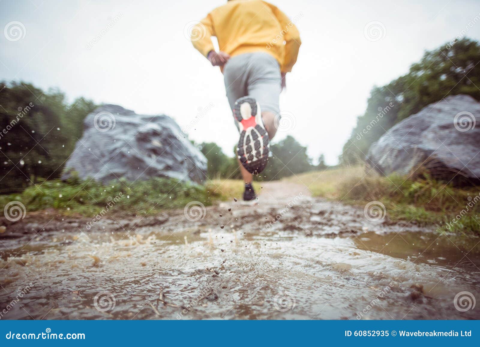 Man Jogging through Muddy Puddles Stock Image - Image of scenic ...