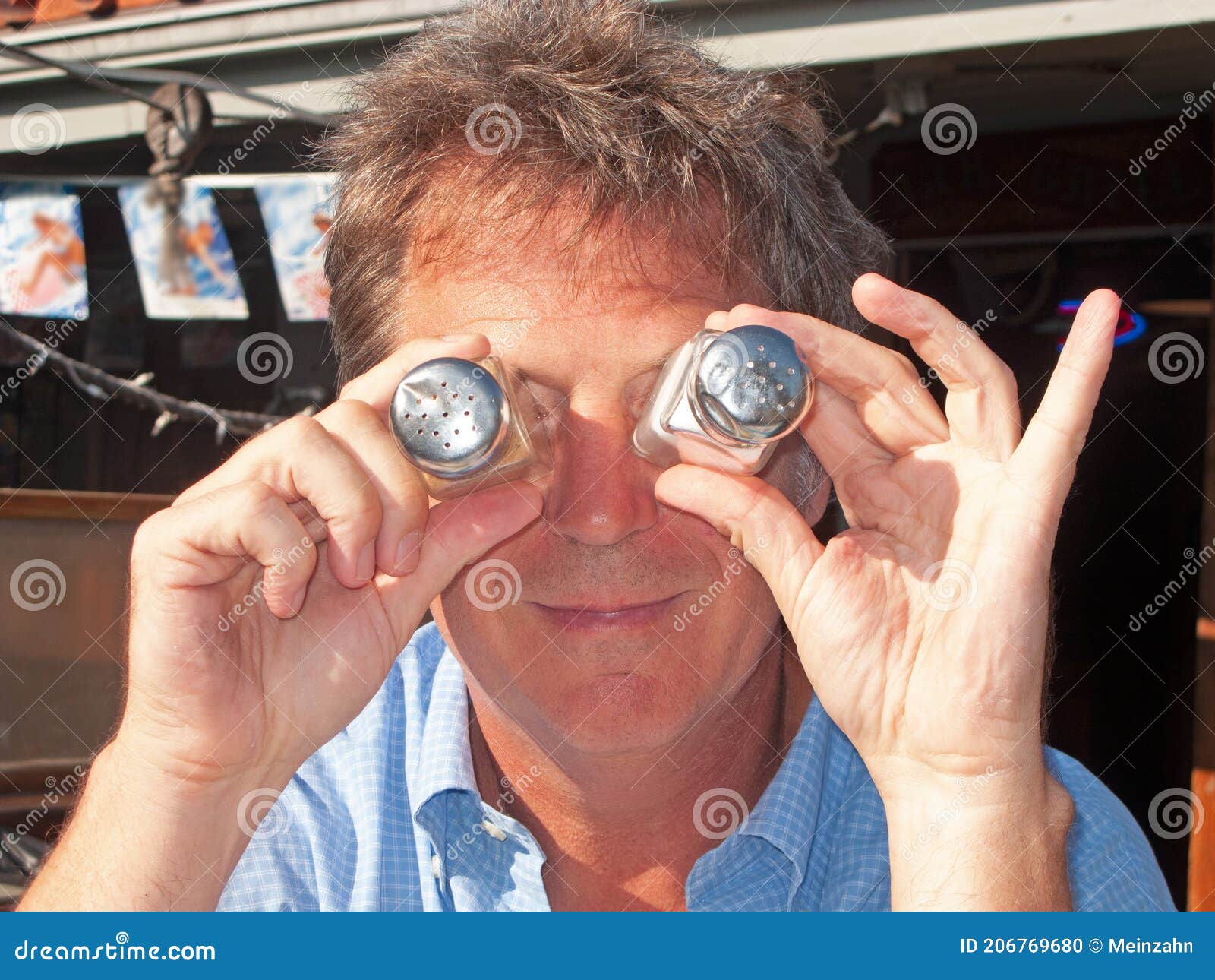 Man is Joking and Putting Salt Spender As Eyes in Front of His Eyes ...