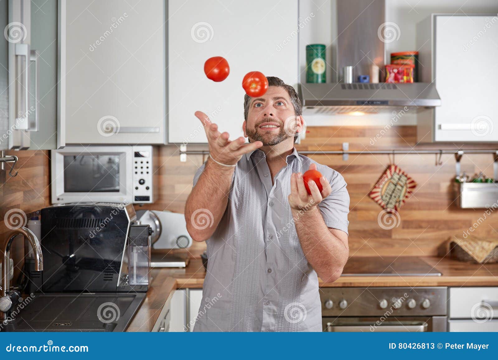 Man Juggling in the Kitchen with Tomatoes Stock Image - Image of chef ...