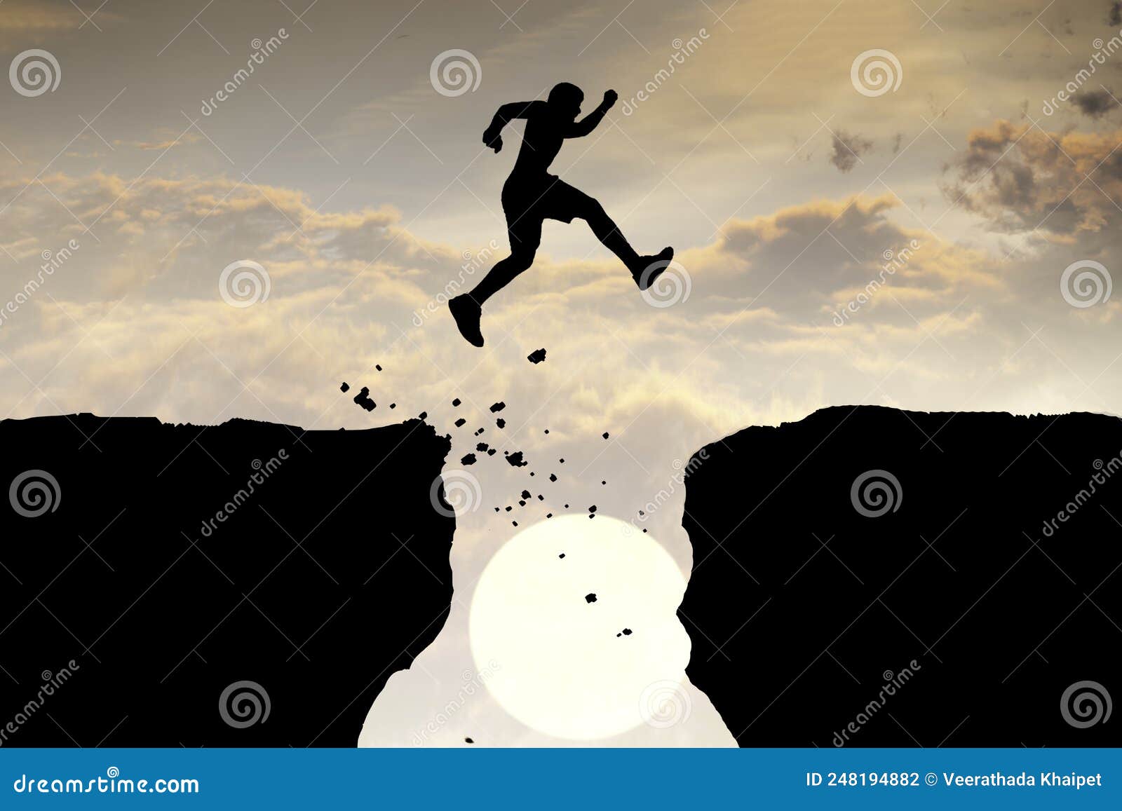 Man Jumping Across a Gap between the Cliffs in the Mountains Stock ...