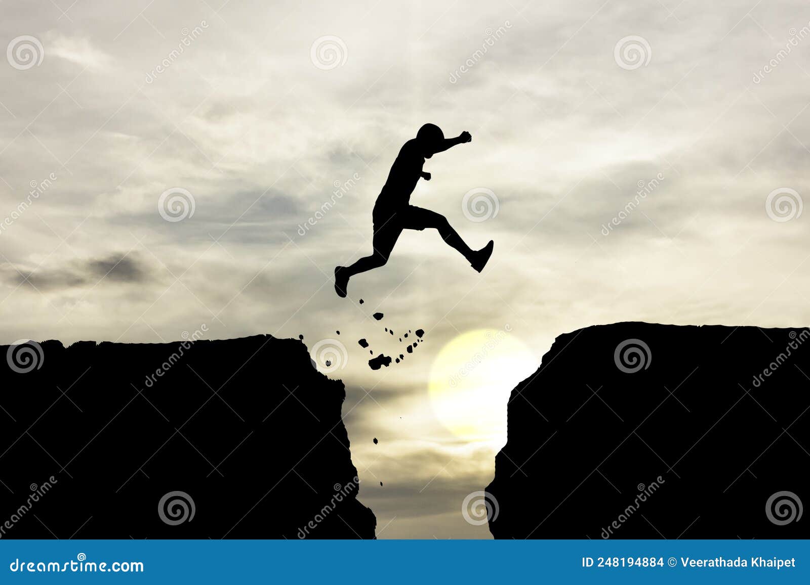 Man Jumping Across a Gap between the Cliffs in the Mountains Stock ...