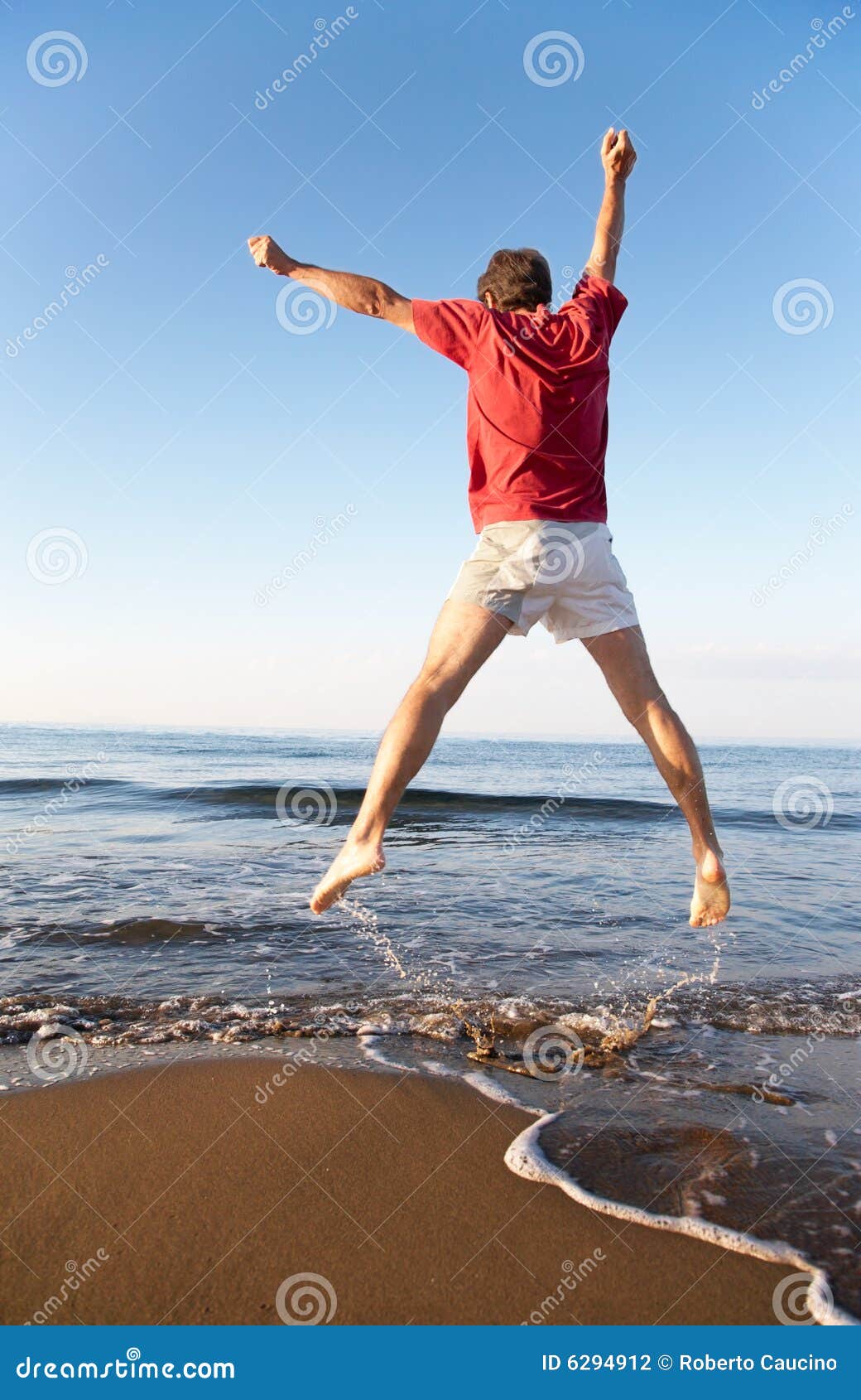Man jumping on the beach stock photo. Image of jumping - 6294912