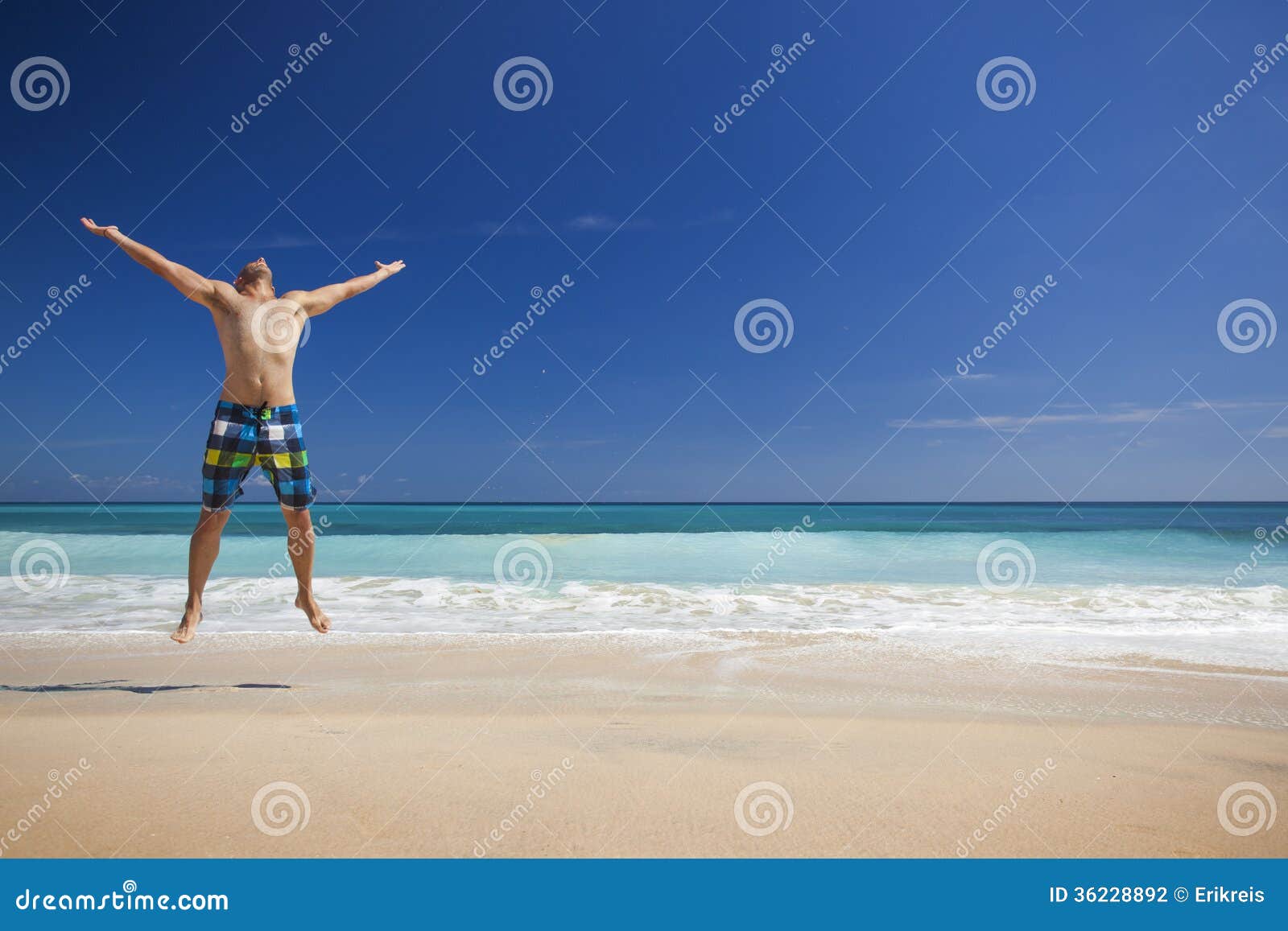 Man jumping on the beach stock photo. Image of exercise - 36228892