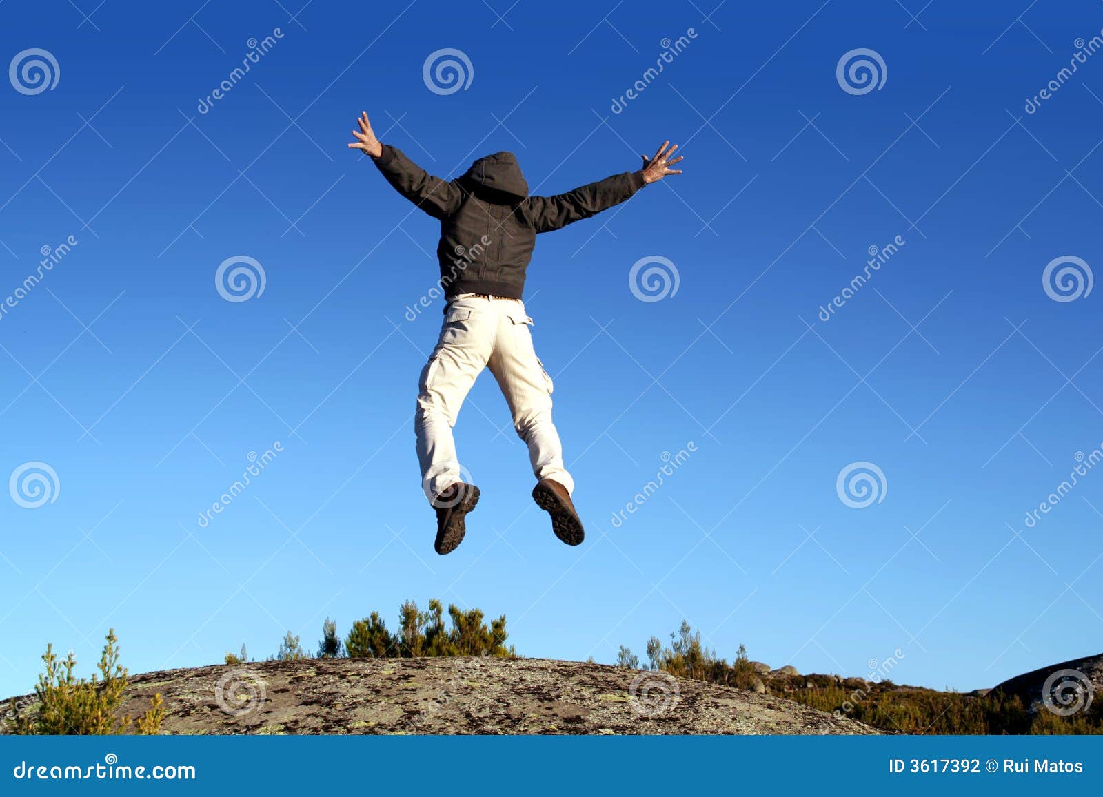 Man jumping from a cliff stock photo. Image of active - 3617392