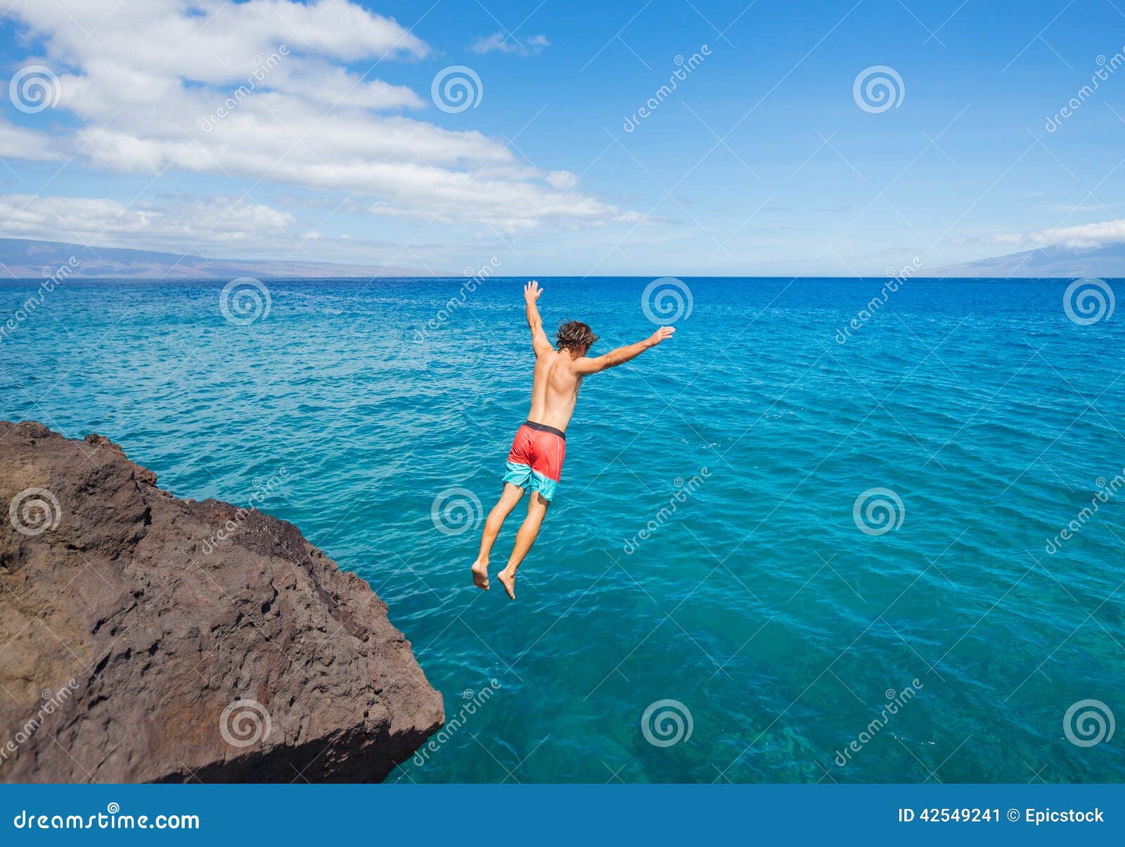 Man Jumping Off Cliff into the Ocean Stock Image - Image of landscape ...