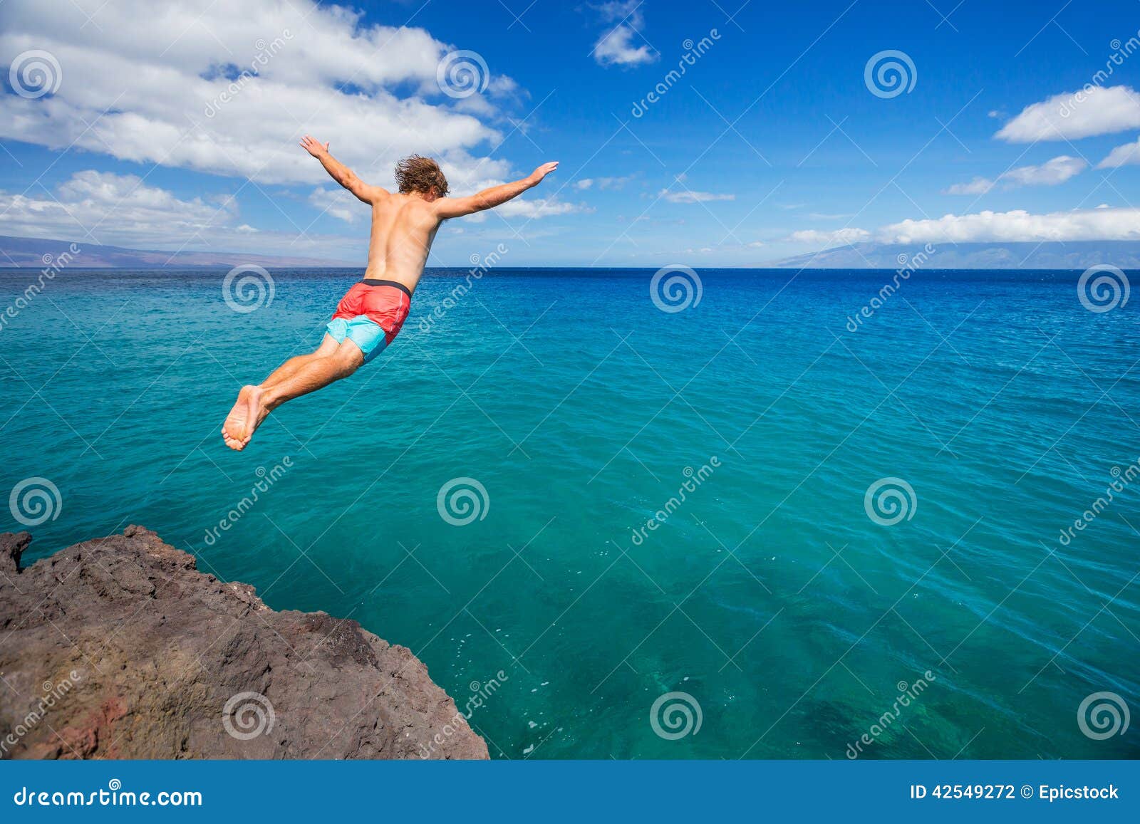 Man Jumping Off Cliff into the Ocean Stock Photo - Image of lifestyle ...